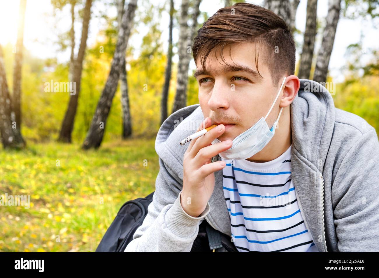 Man smoking cigarette in the forest hi-res stock photography and images ...