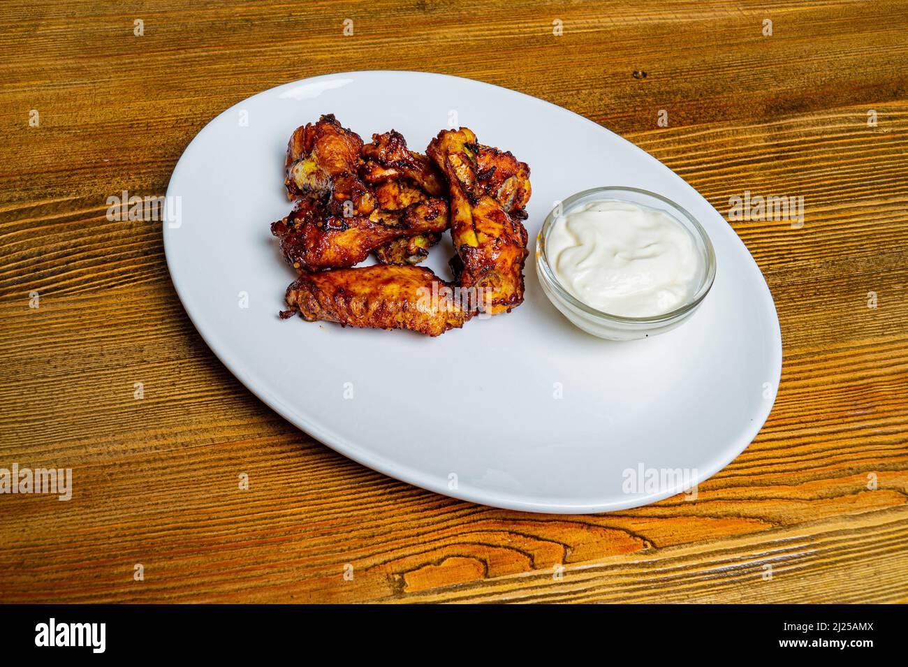 Fresh fried chicken on a white plate set on a wood table Stock Photo ...