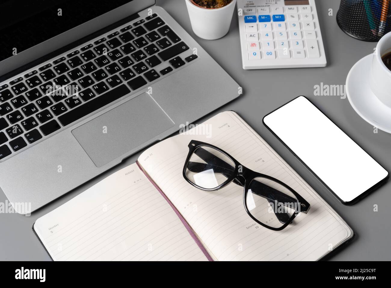 Notepad is on top of office desk table with laptop and supplies Stock ...