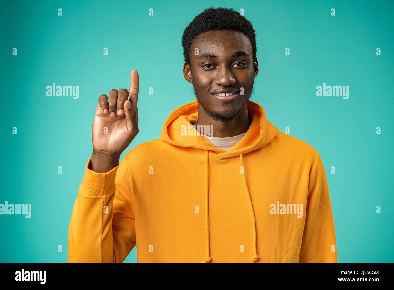 Happy African American man pointing finger at copy space Stock Photo ...