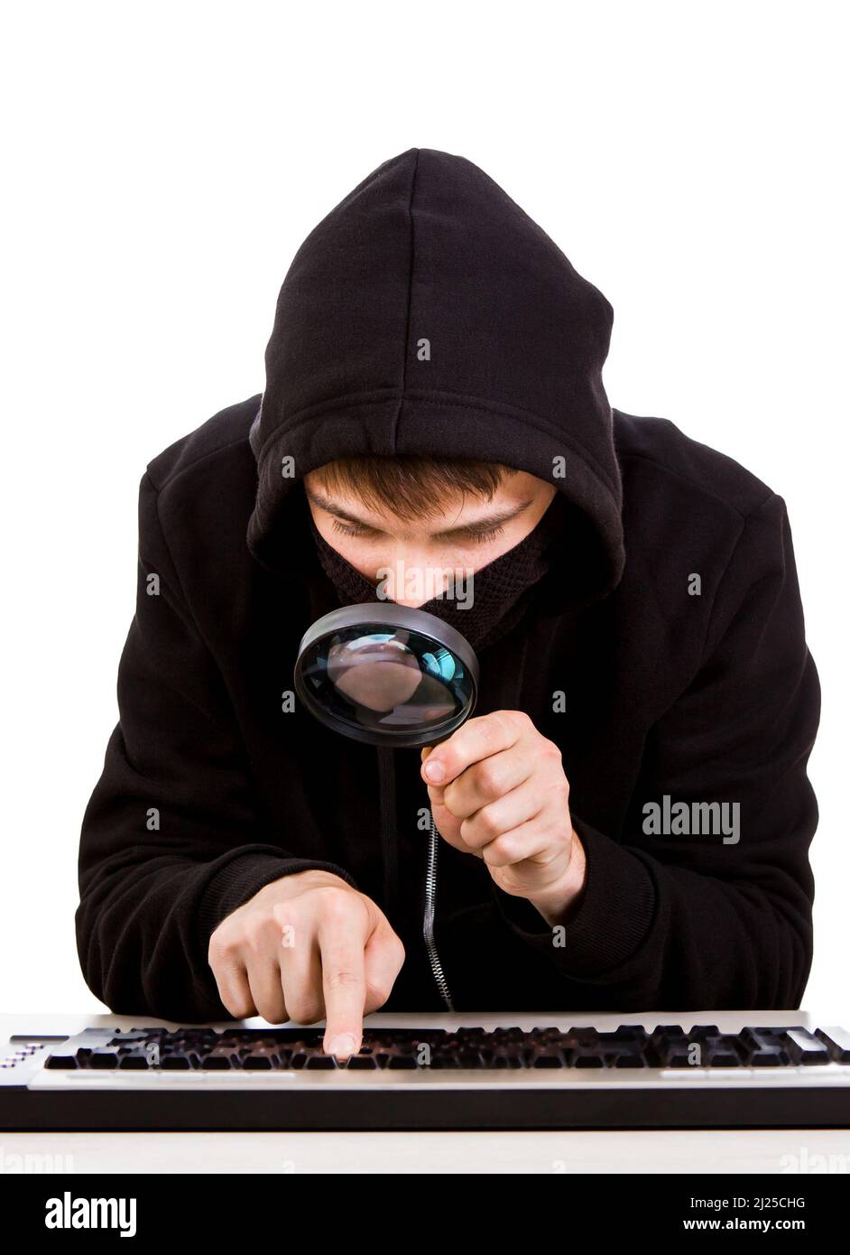 Hacker with a Computer Keyboard using a Magnifying Glass on the White ...