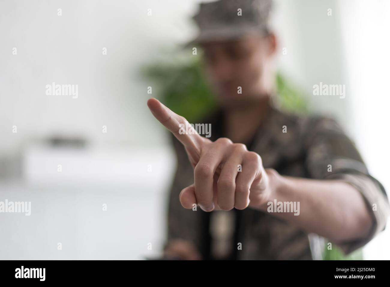 military man pointing with index finger Stock Photo - Alamy
