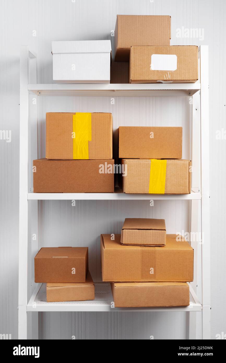 Stack of cardboard package boxes on wooden rack Stock Photo - Alamy