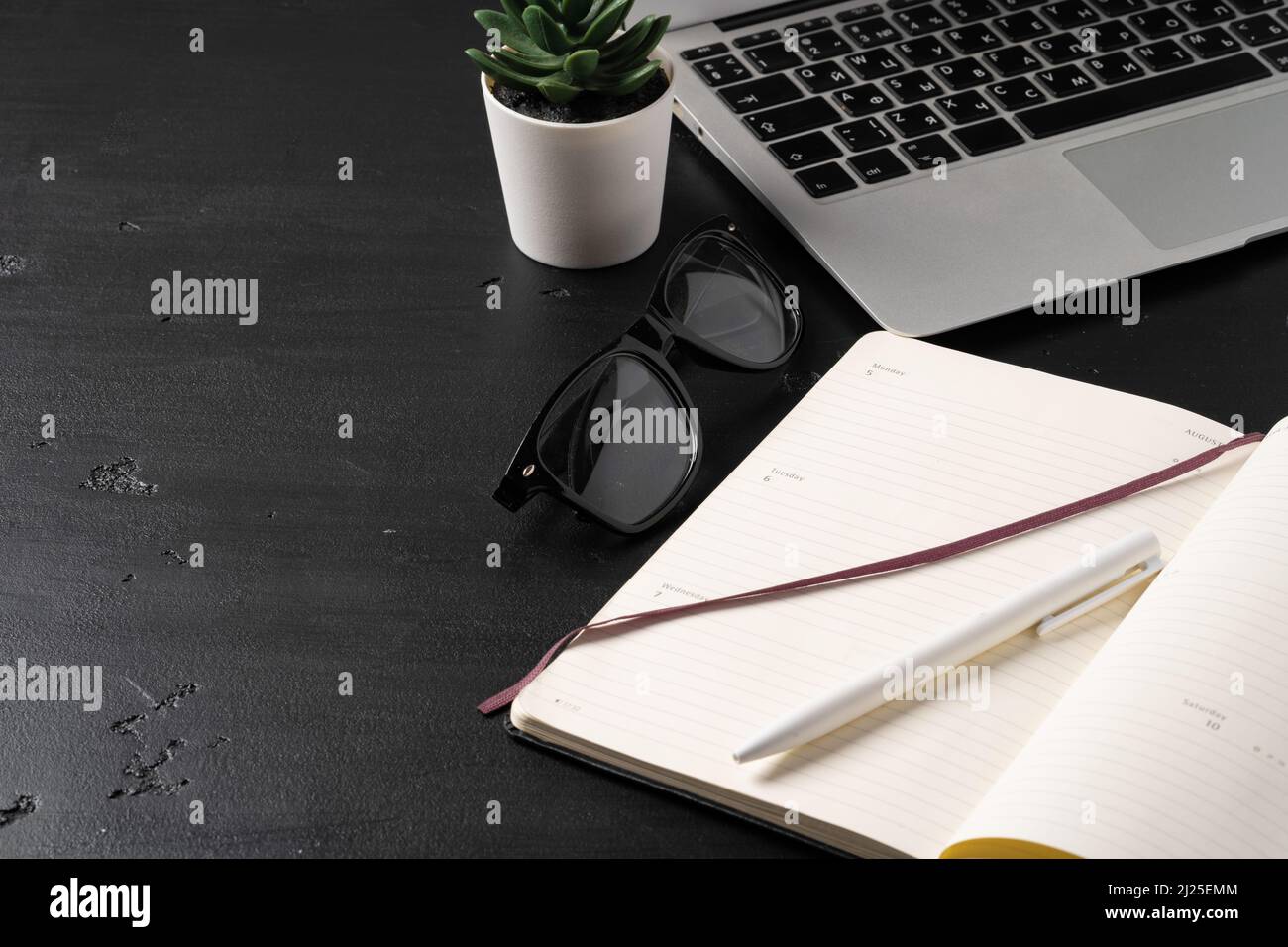 Notepad is on top of office desk table with laptop and supplies Stock ...