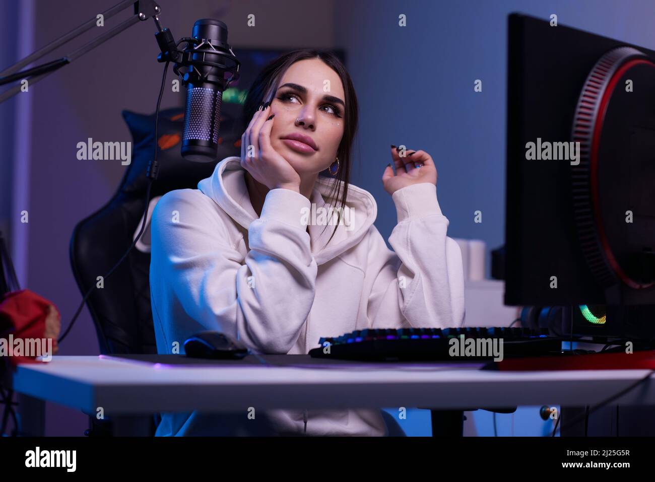 Happy woman putting on headphones and playing computer game. Female ...