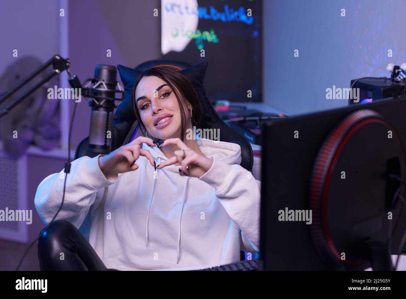 Happy woman putting on headphones and playing computer game. Female ...