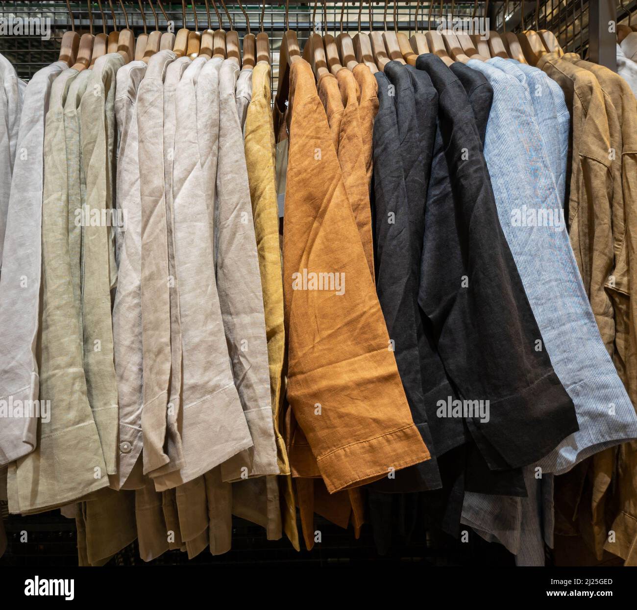 Cotton men shirts hanging on rack in closet wardrobe Stock Photo - Alamy
