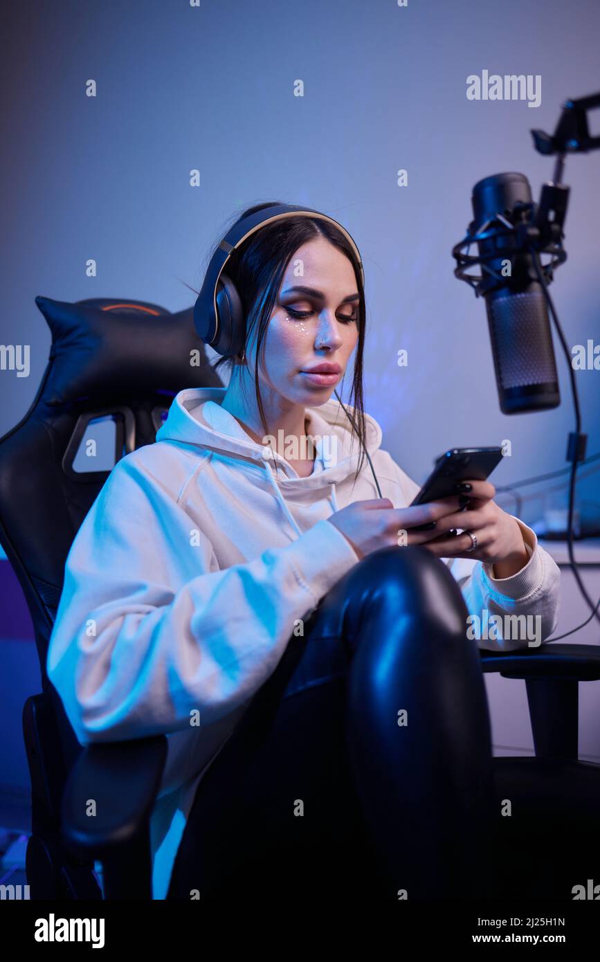 Happy Woman Putting On Headphones And Playing Computer Game Female Gamer In Glasses Sitting And