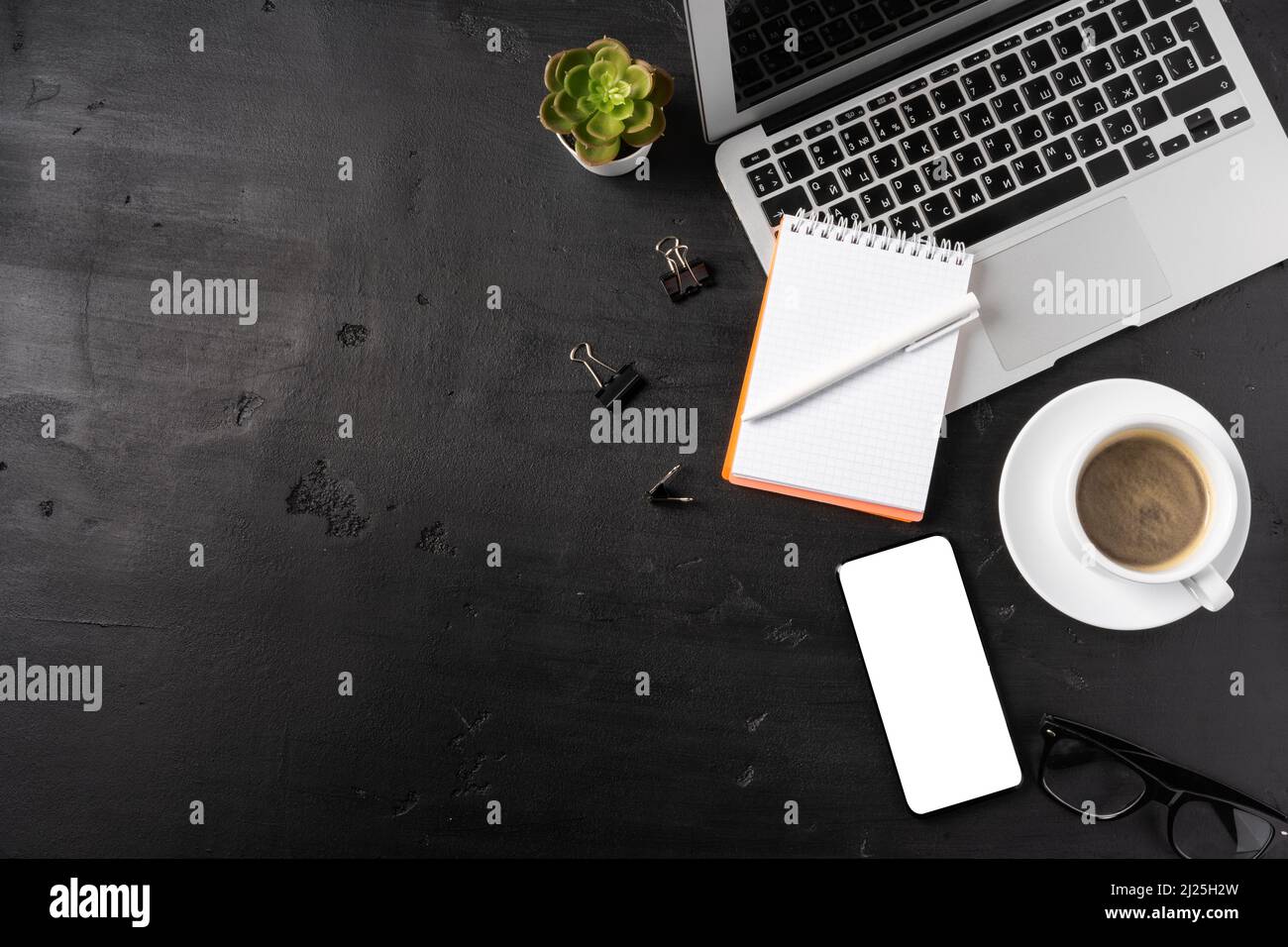 Notepad is on top of office desk table with laptop and supplies Stock ...