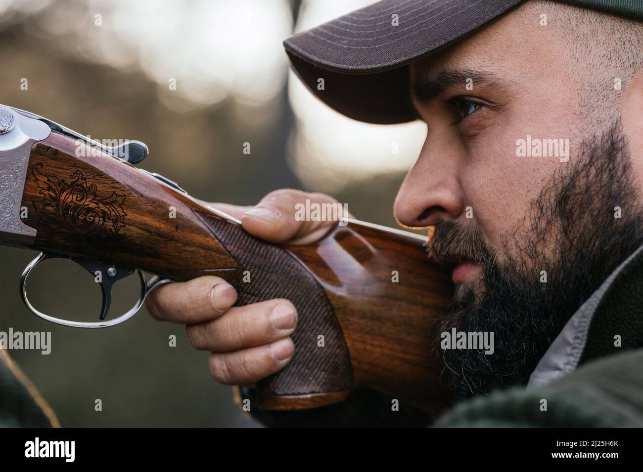Hunter aiming with his gun in nature Stock Photo - Alamy