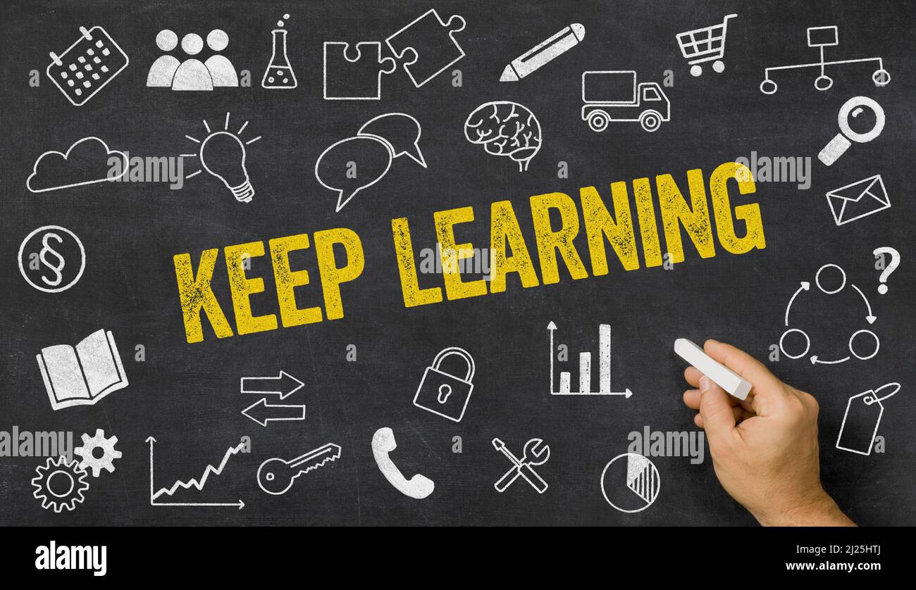 Keep learning written on a blackboard with icons Stock Photo - Alamy