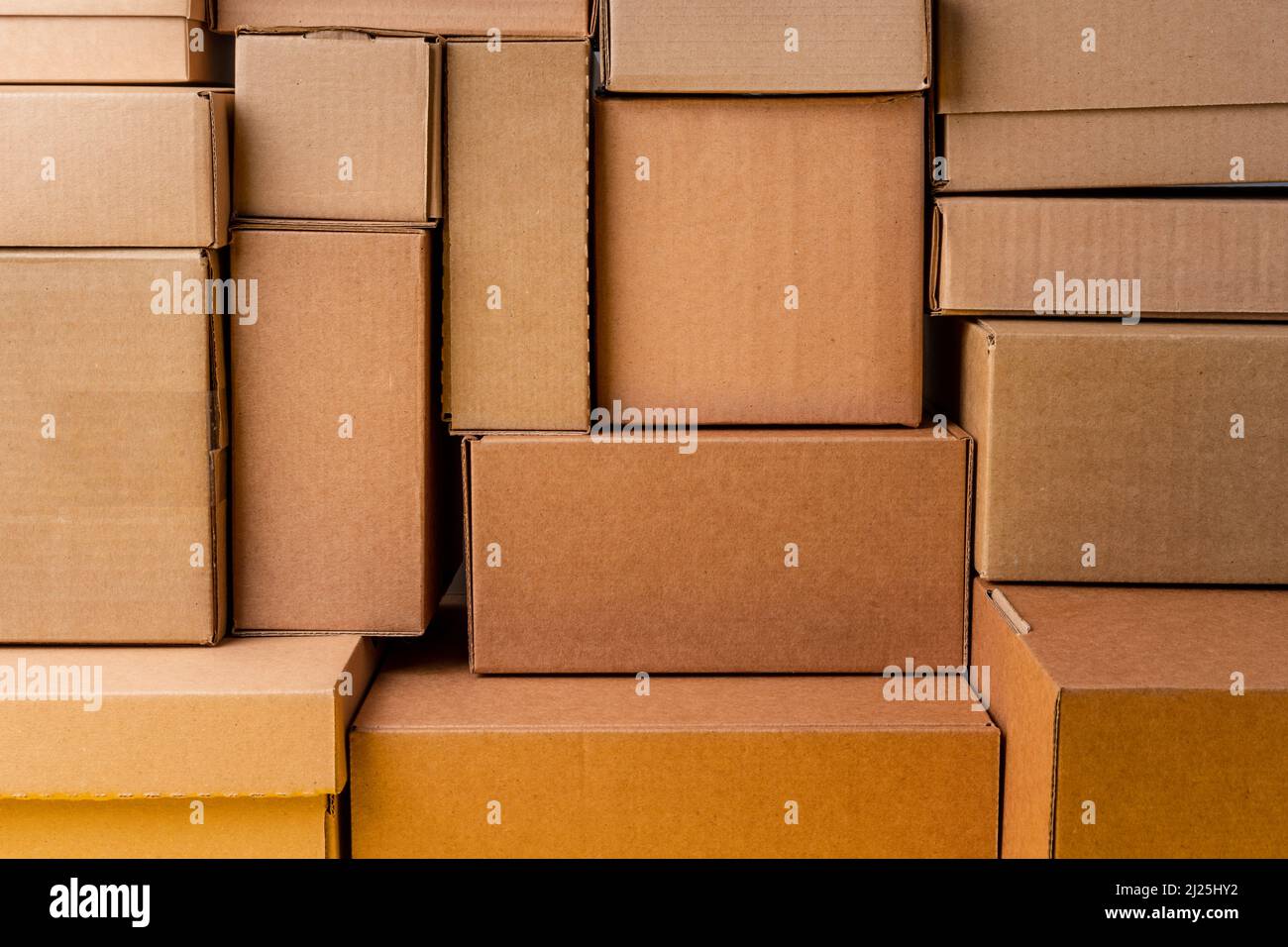Cardboard boxes stacked in a pile as a background Stock Photo - Alamy