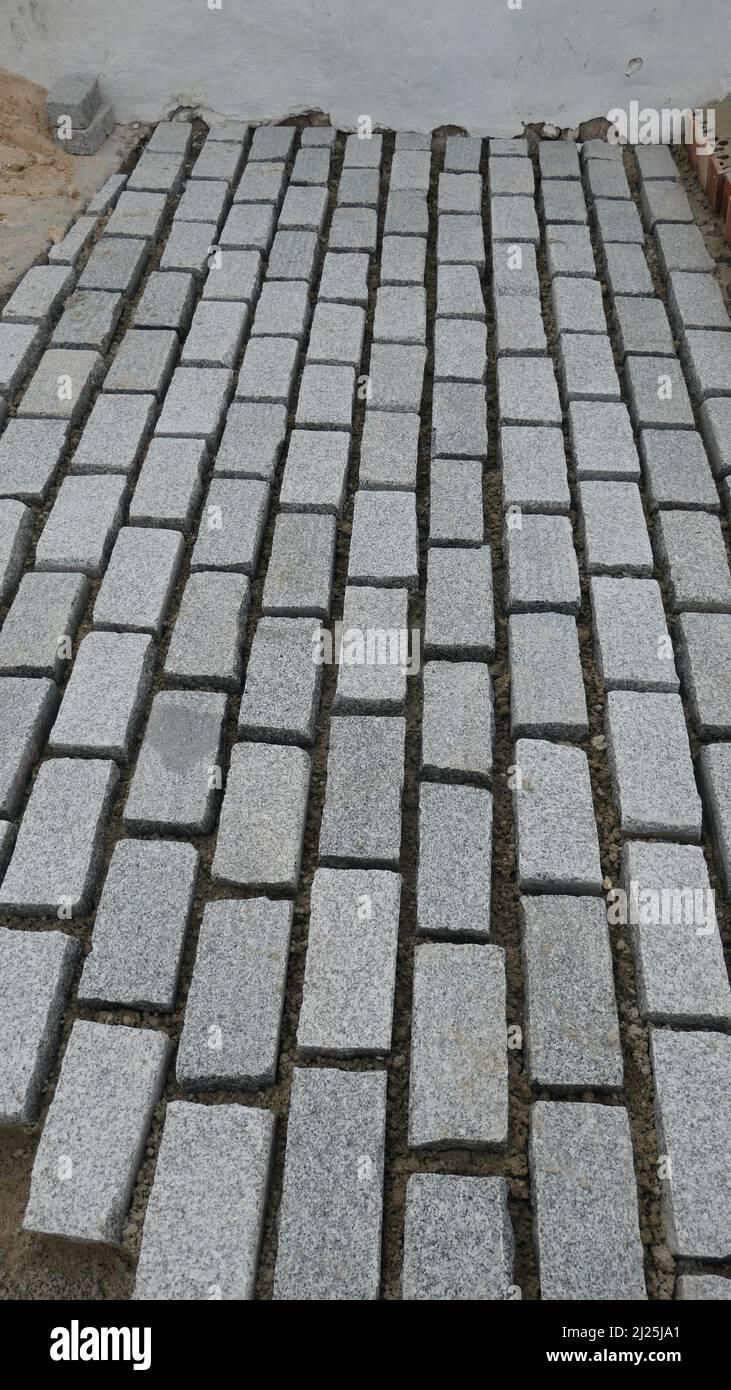 Oblong paving stones awaiting grouting in village street in Andalusia ...