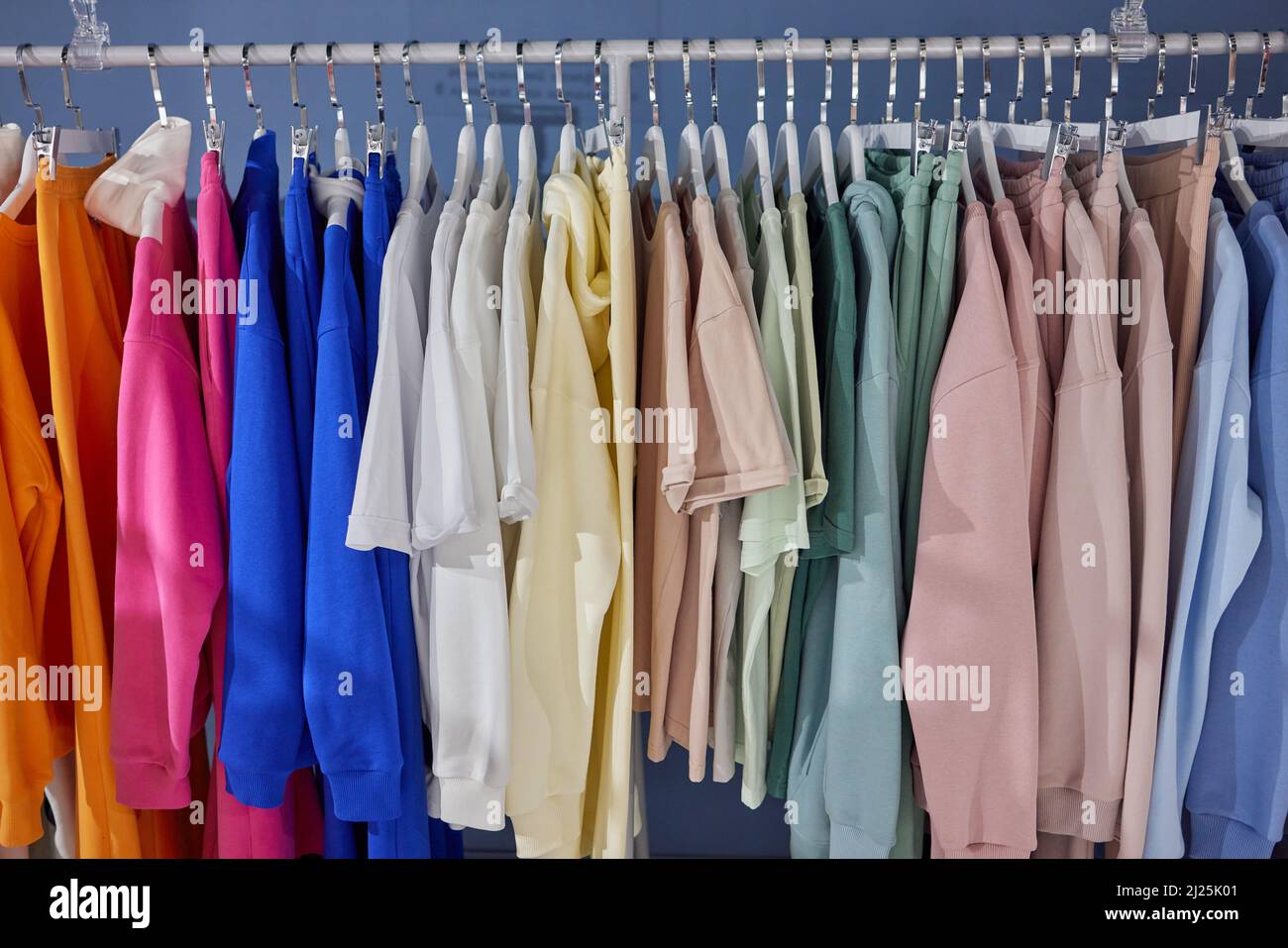 Fashion clothes on clothing rack, Bright colorful cotton shirts on ...