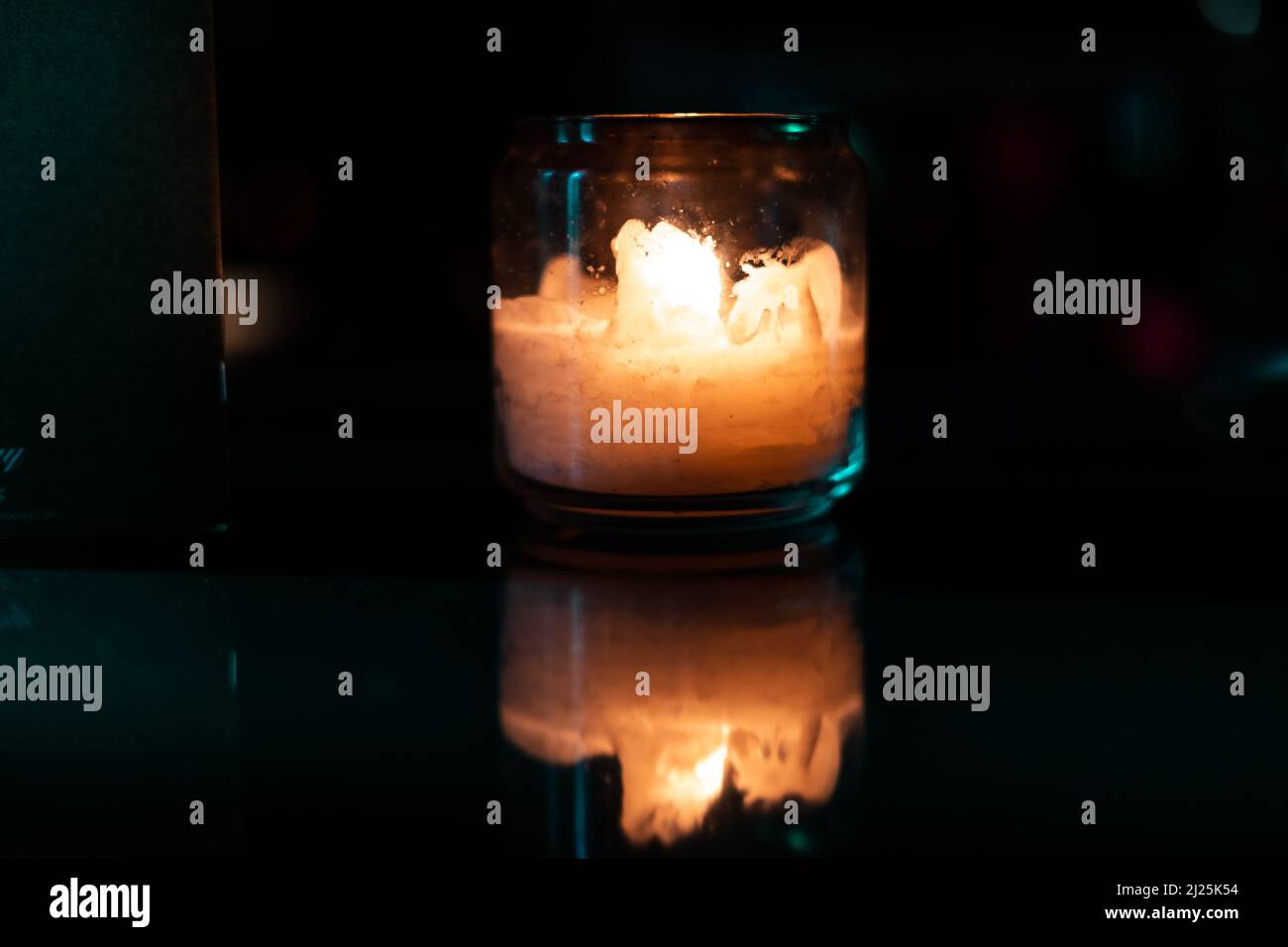 Glass candle with its reflection Stock Photo - Alamy