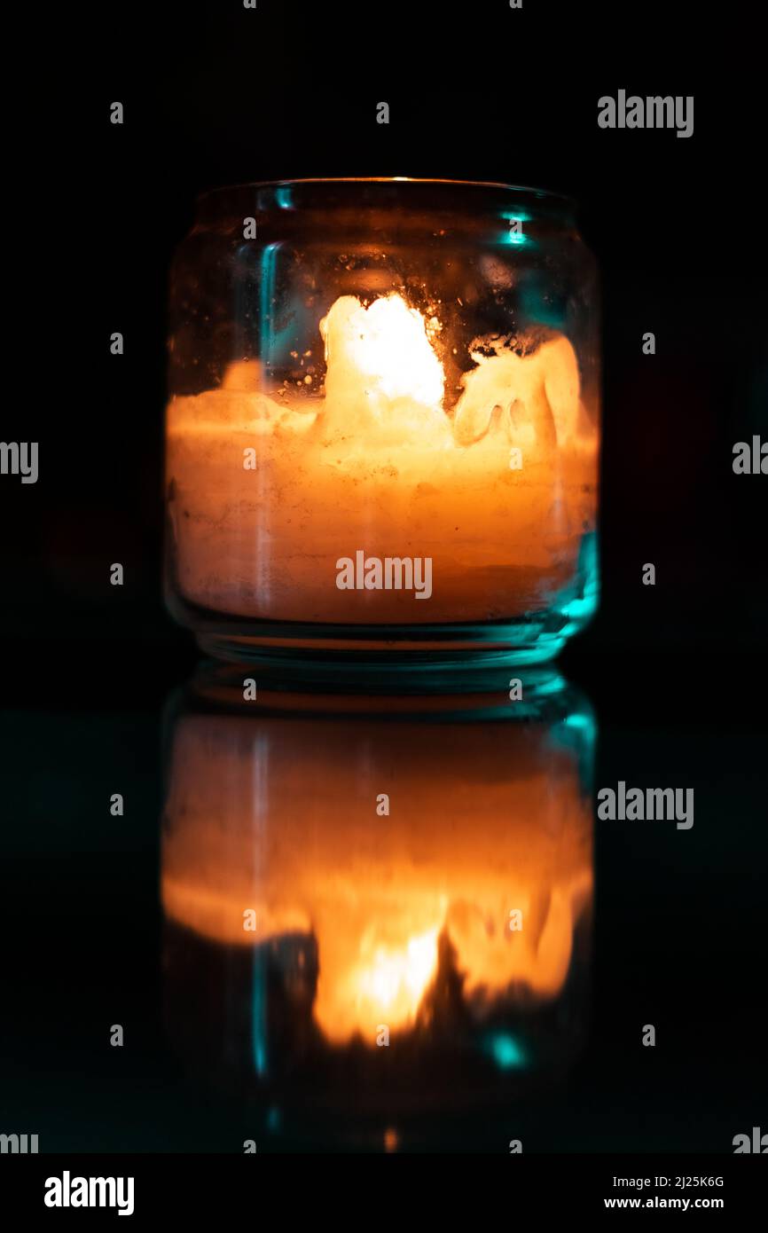 Glass candle with its reflection Stock Photo - Alamy
