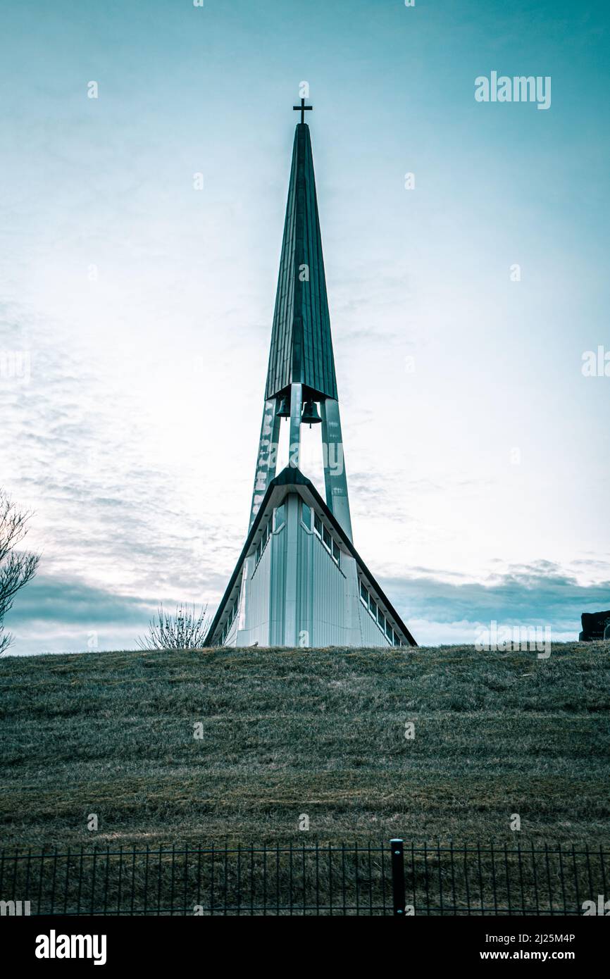 A vertical shot of the spire of Mosfellskirkja - an Icelandic church ...