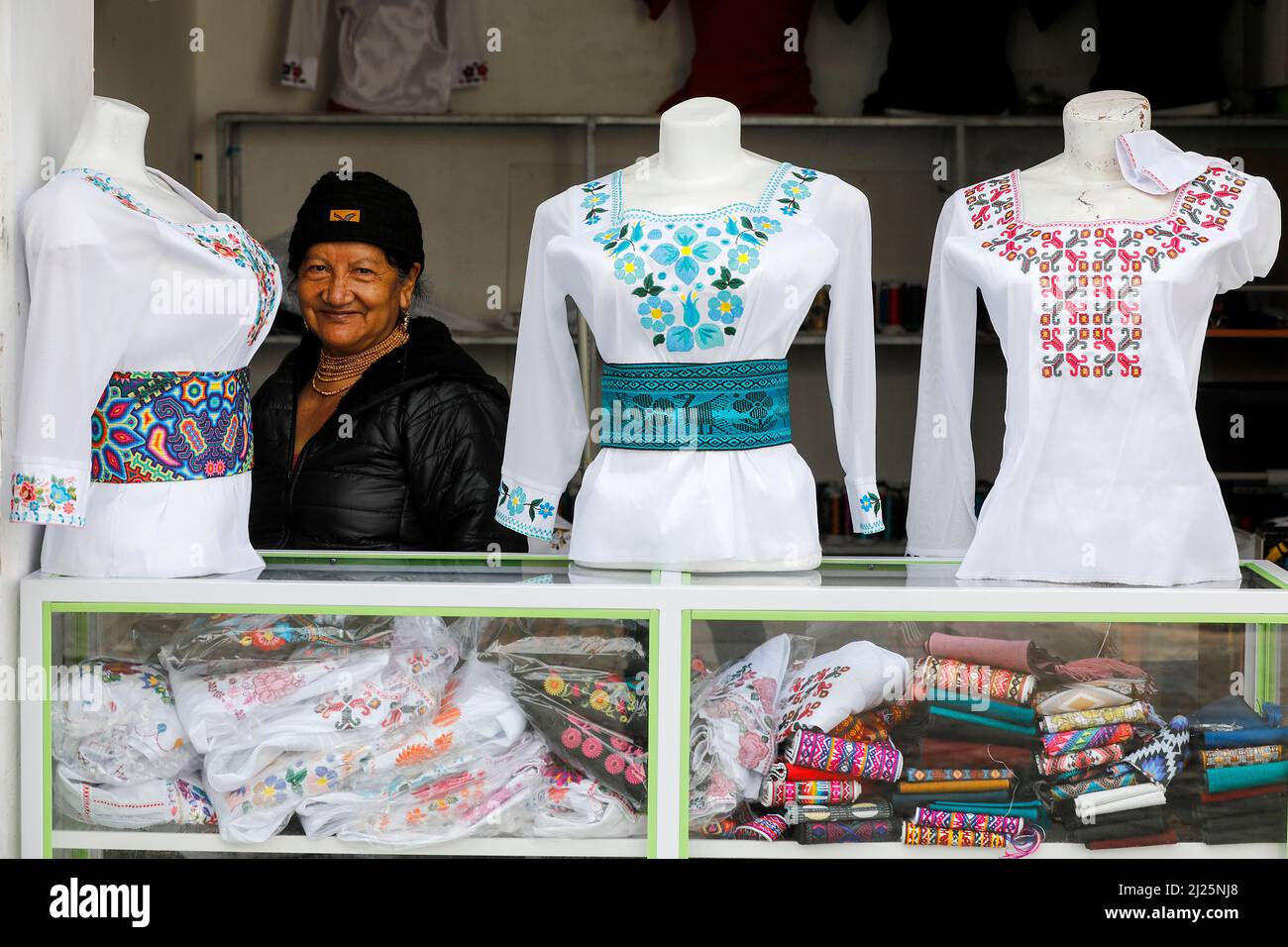 Shop selling embroidered clothing in Quito, Ecuador Stock Photo - Alamy