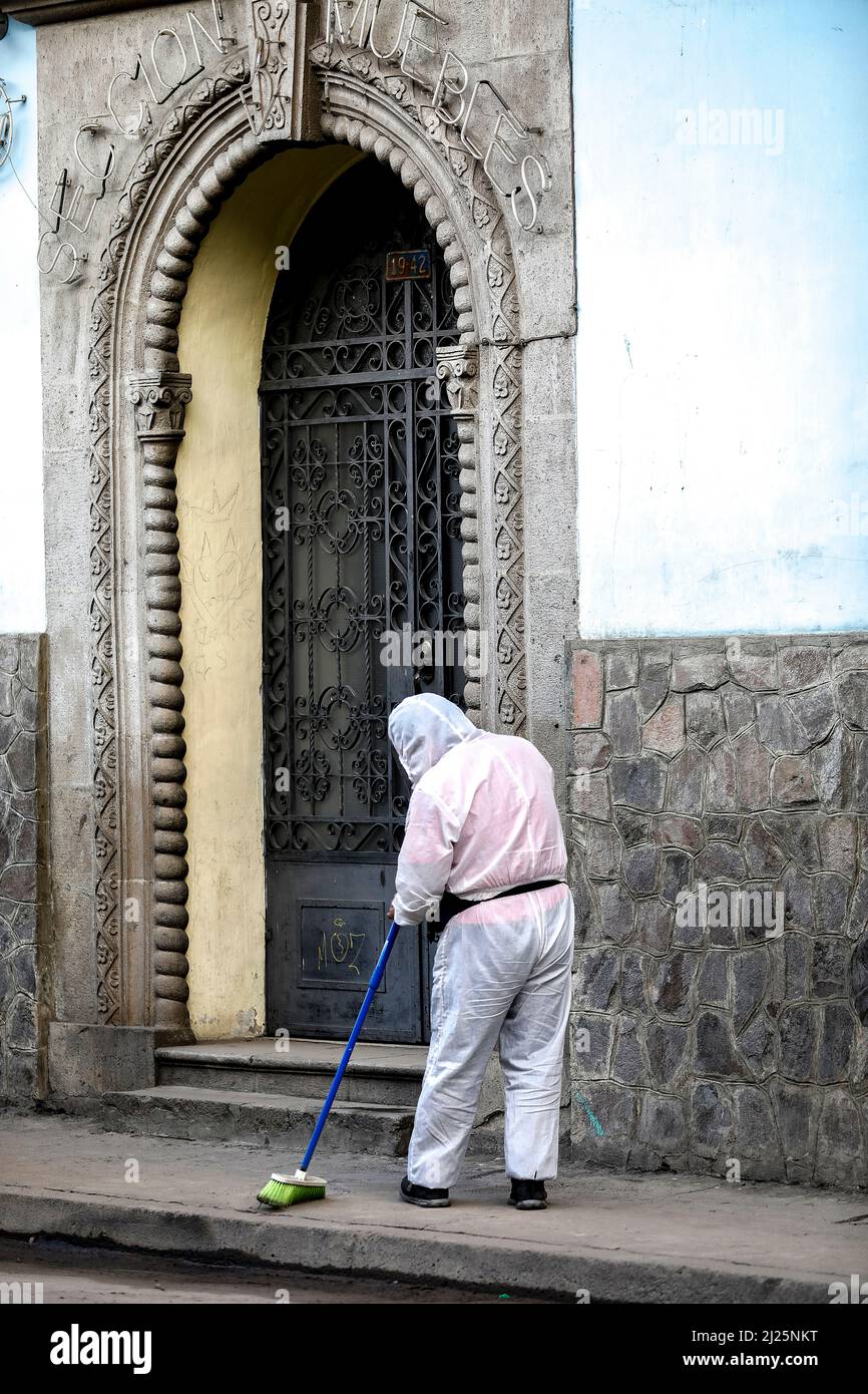 Shopkeeper cleaning spewed vocano ash in Riobamba, Ecuador Stock Photo ...