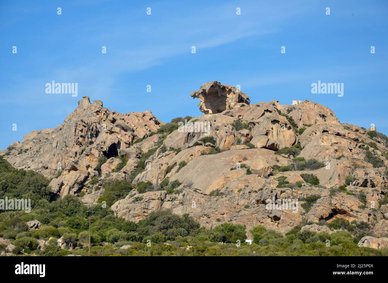 Unusual rock formation on a hill under blue sky on the island of ...