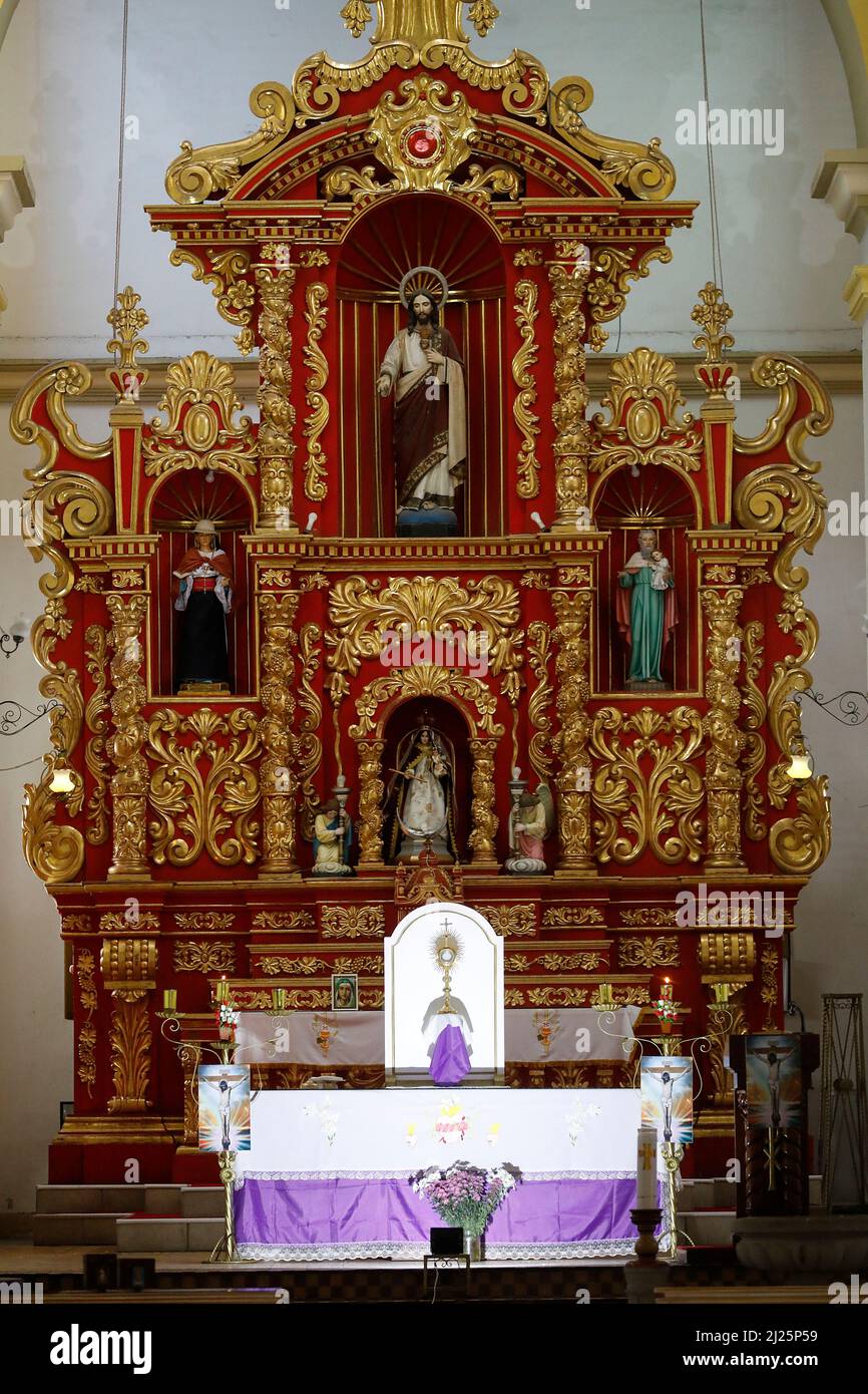 Altar and reredos in a catholic church, Cotacachi, Ecuador Stock Photo ...