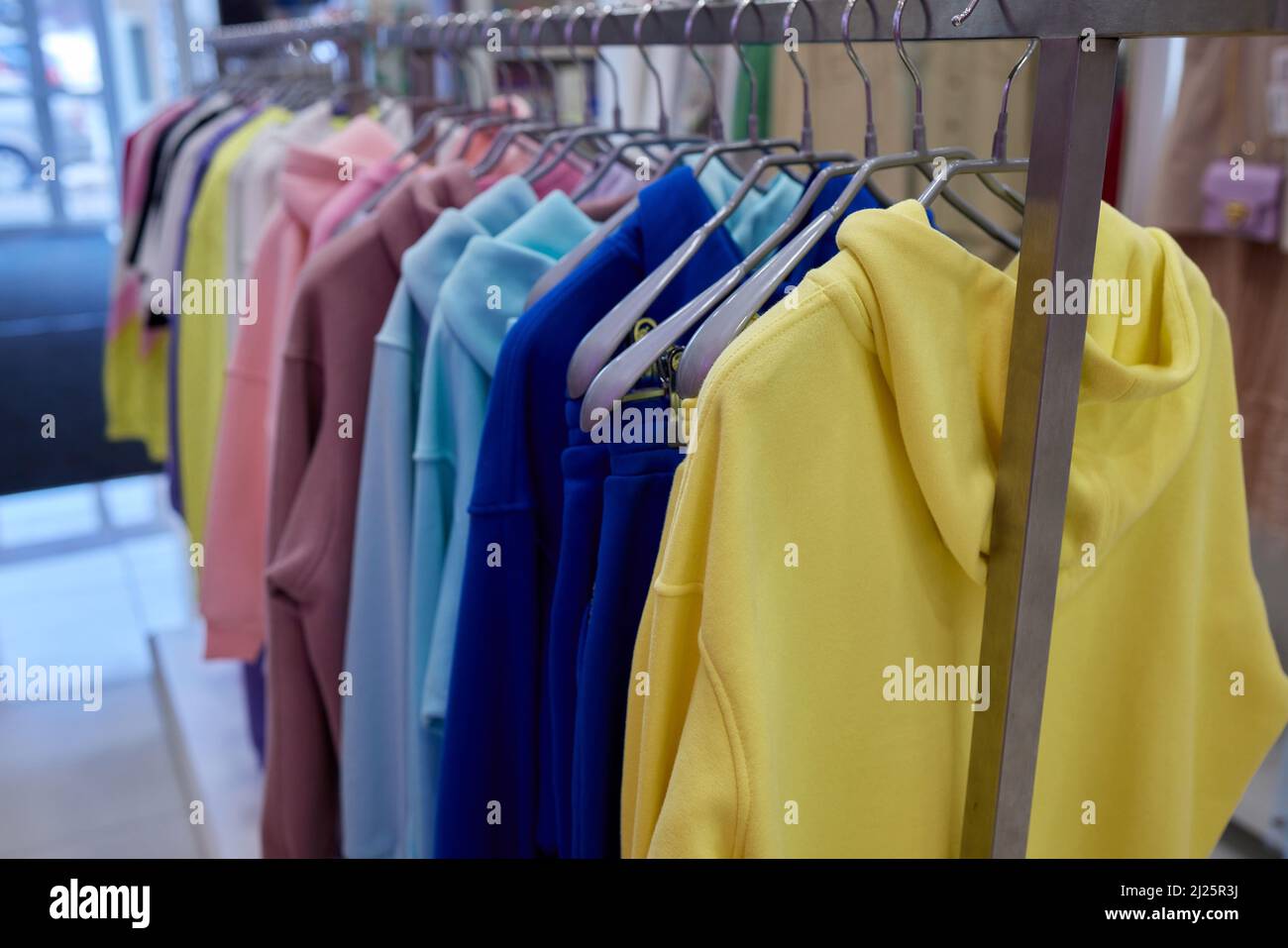 Fashion clothes on clothing rack, Bright colorful cotton shirts on ...