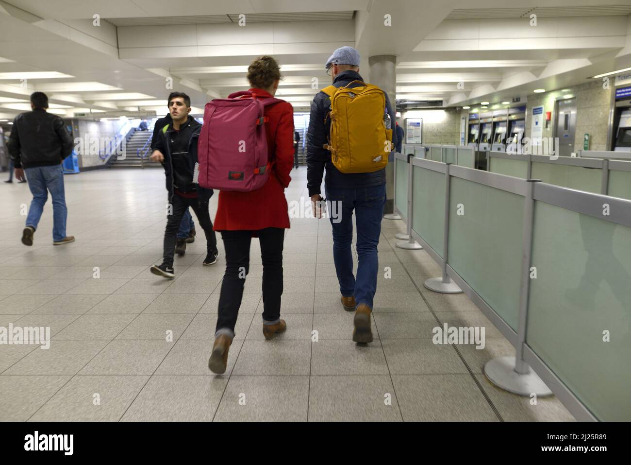 London, England, UK. Two people with colourful backpacks in Victoria ...