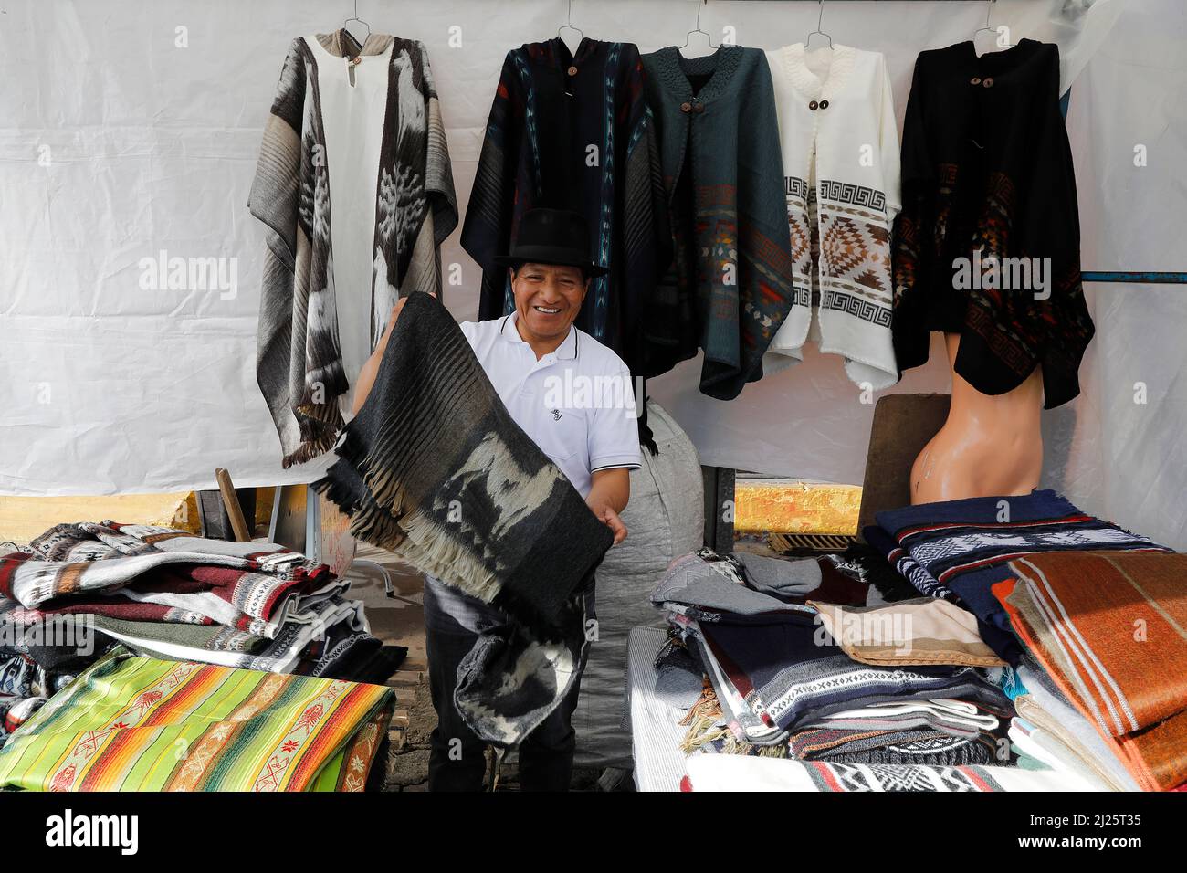 Native Ecuadorian selling clothes at Otavalo market, Ecuador Stock ...