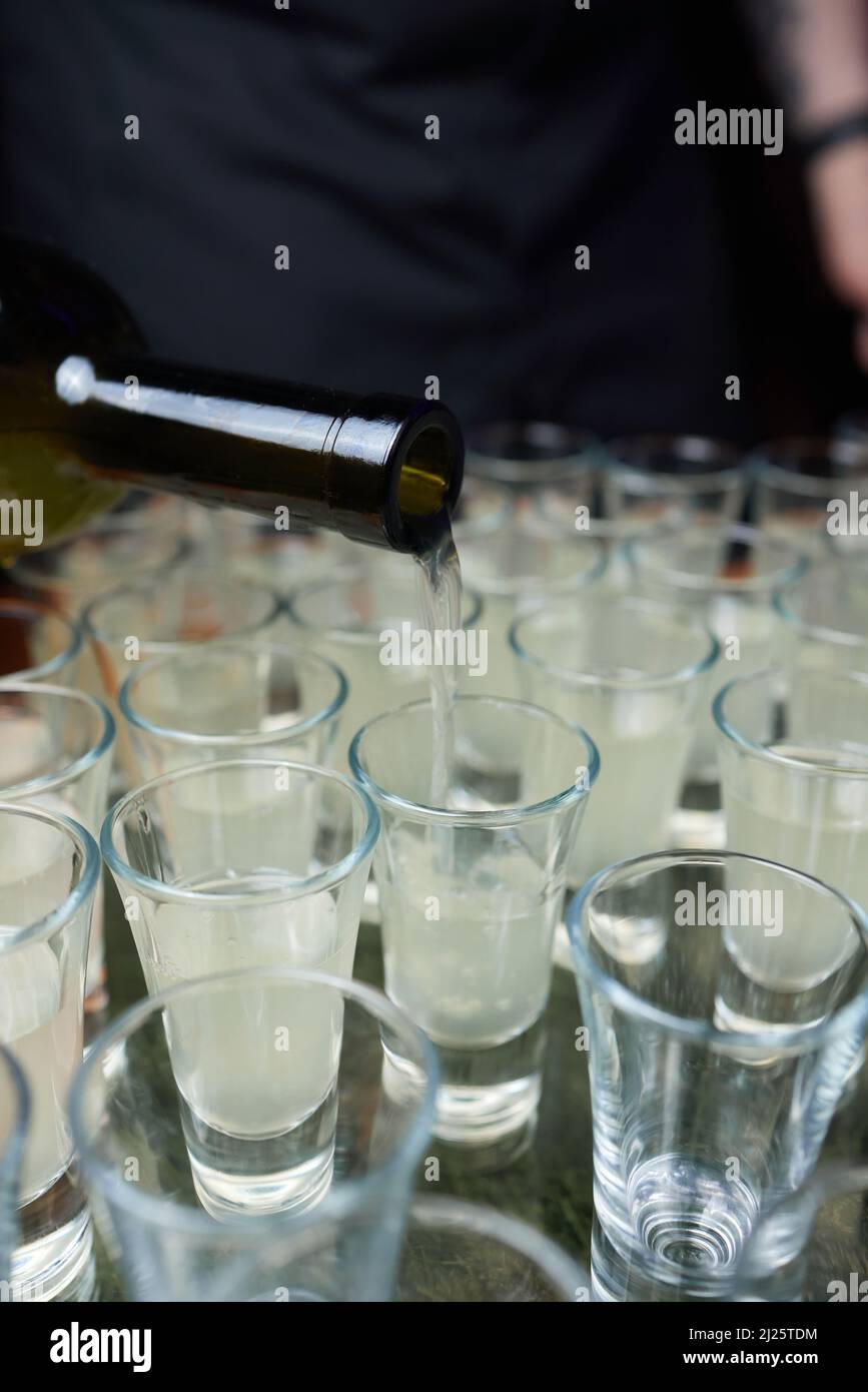 Barman pouring hard spirit glasses hi-res stock photography and images ...