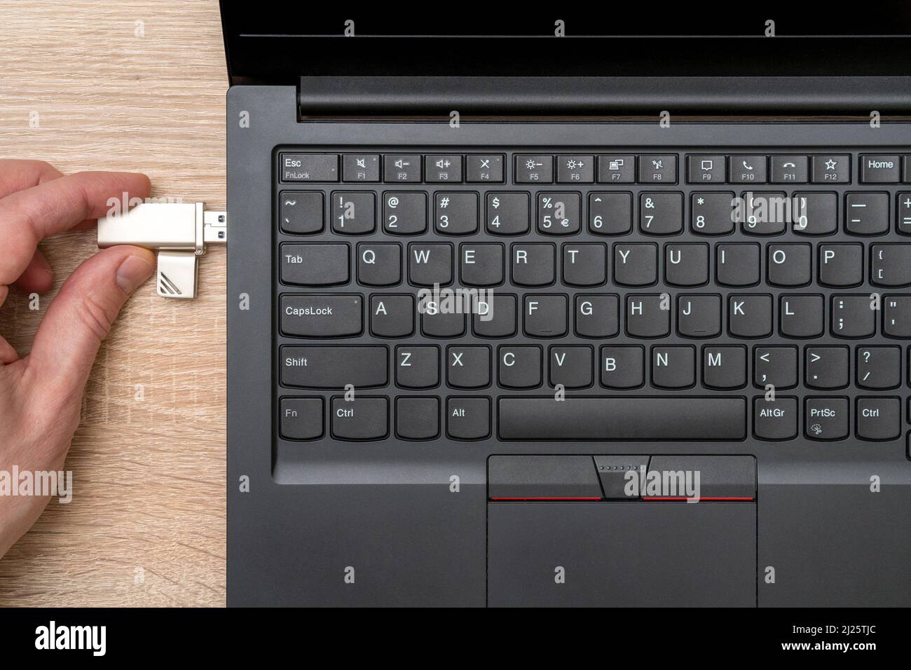 Plugging removable flash disk memory into laptop USB slot. The concept ...