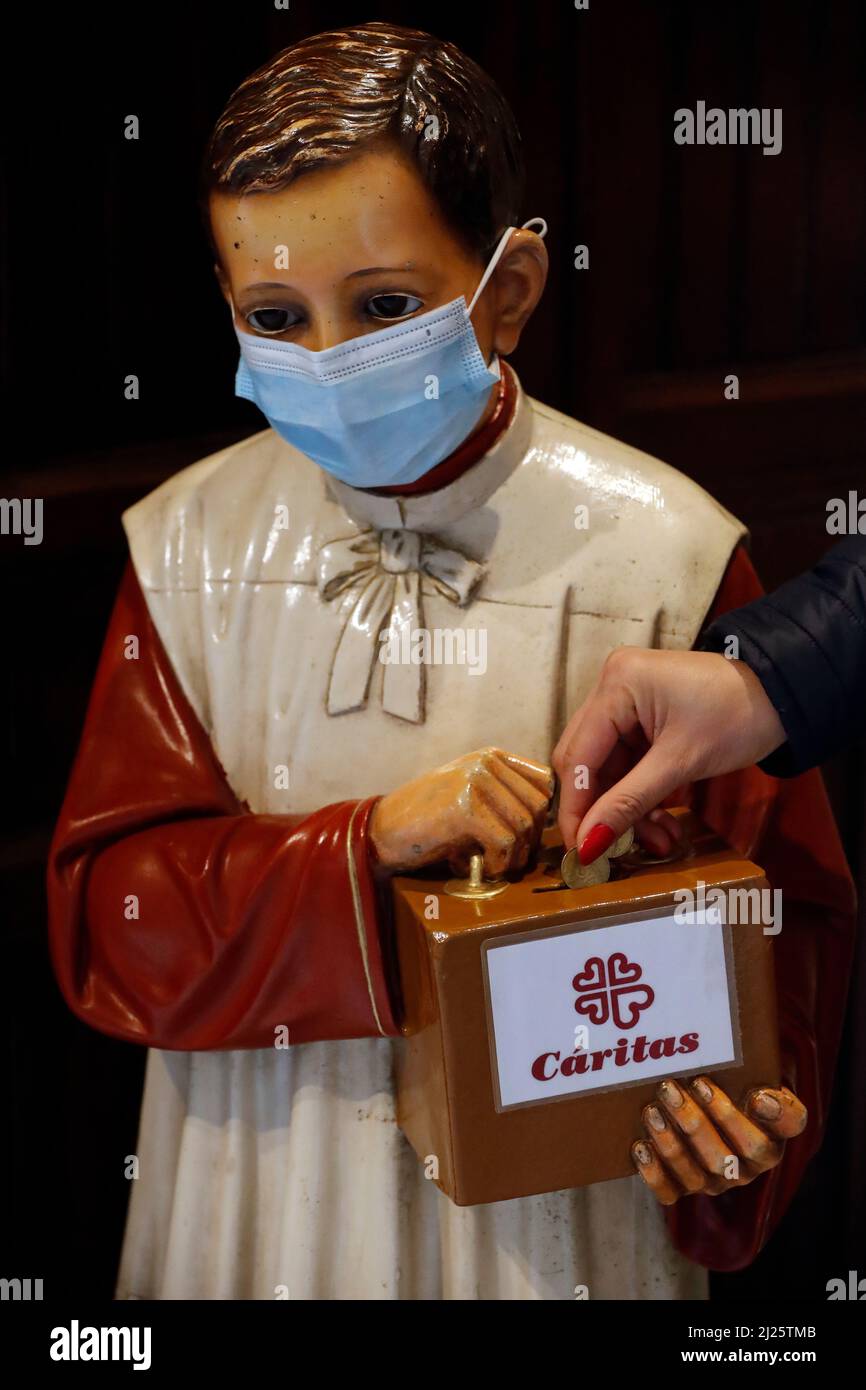 Almudena Cathedral. Quest for caritas, catholic NGO Stock Photo - Alamy