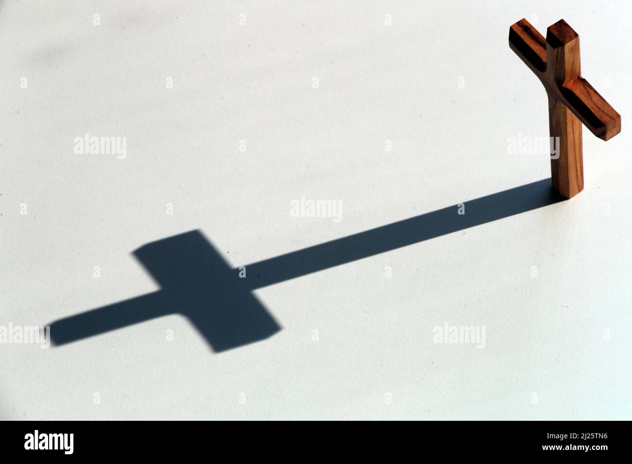 A wooden Easter cross symbol of the Crucifixion of Christ with a shadow ...
