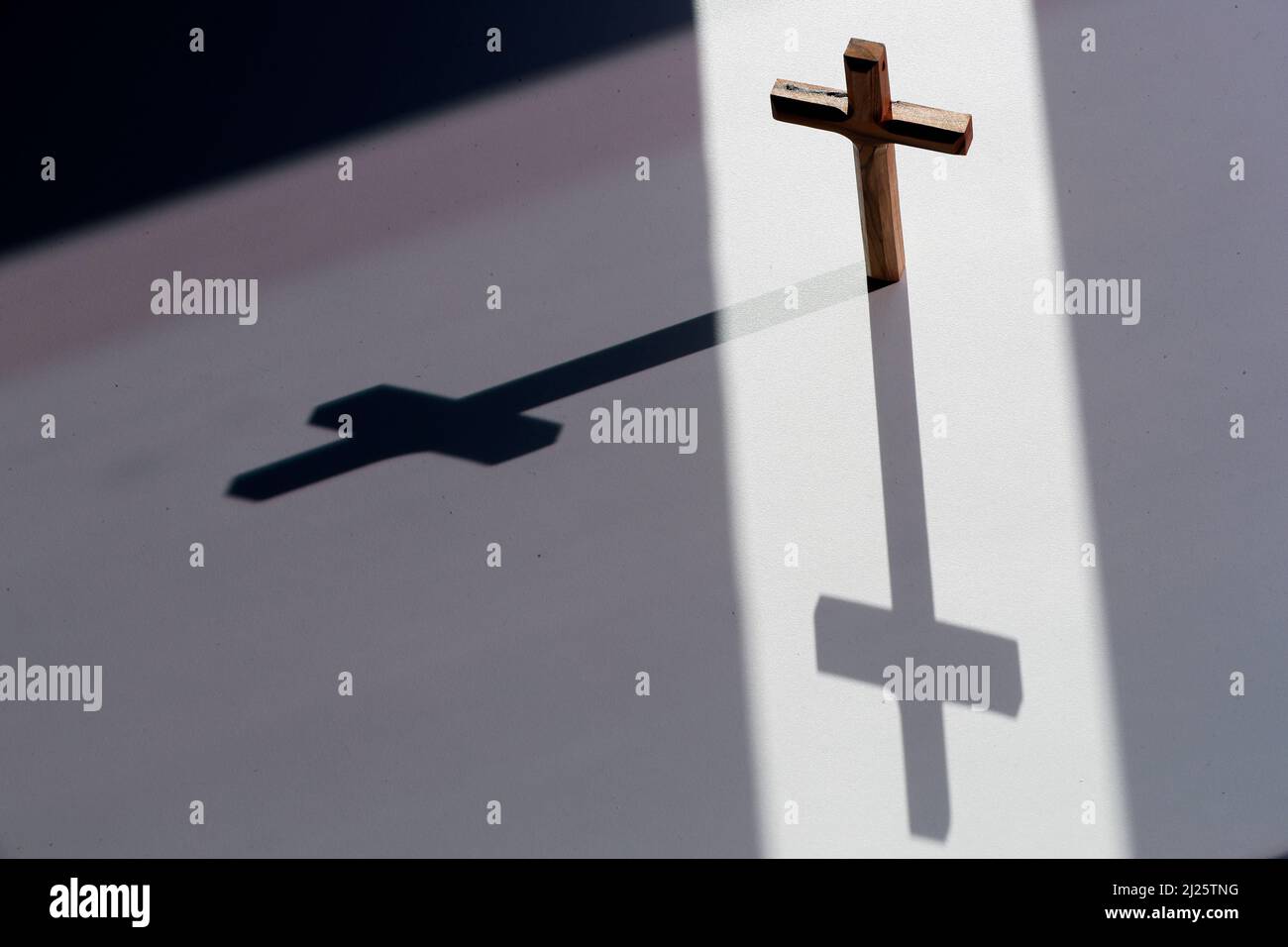 A wooden Easter cross symbol of the Crucifixion of Christ with a shadow ...