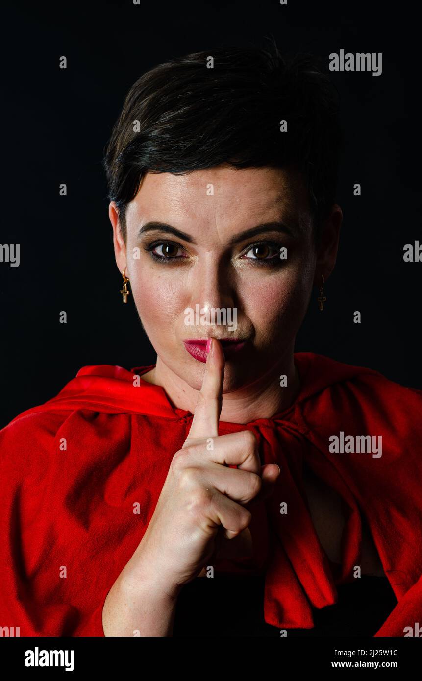 beautiful woman red cloak with red flowers roses in studio. Woman Red ...