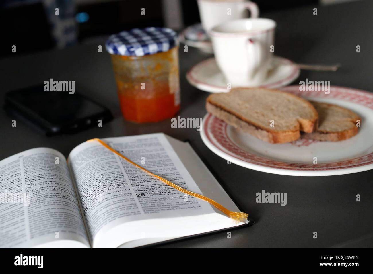 Open bible on a breakfast table. Church candels in church. Woman ...
