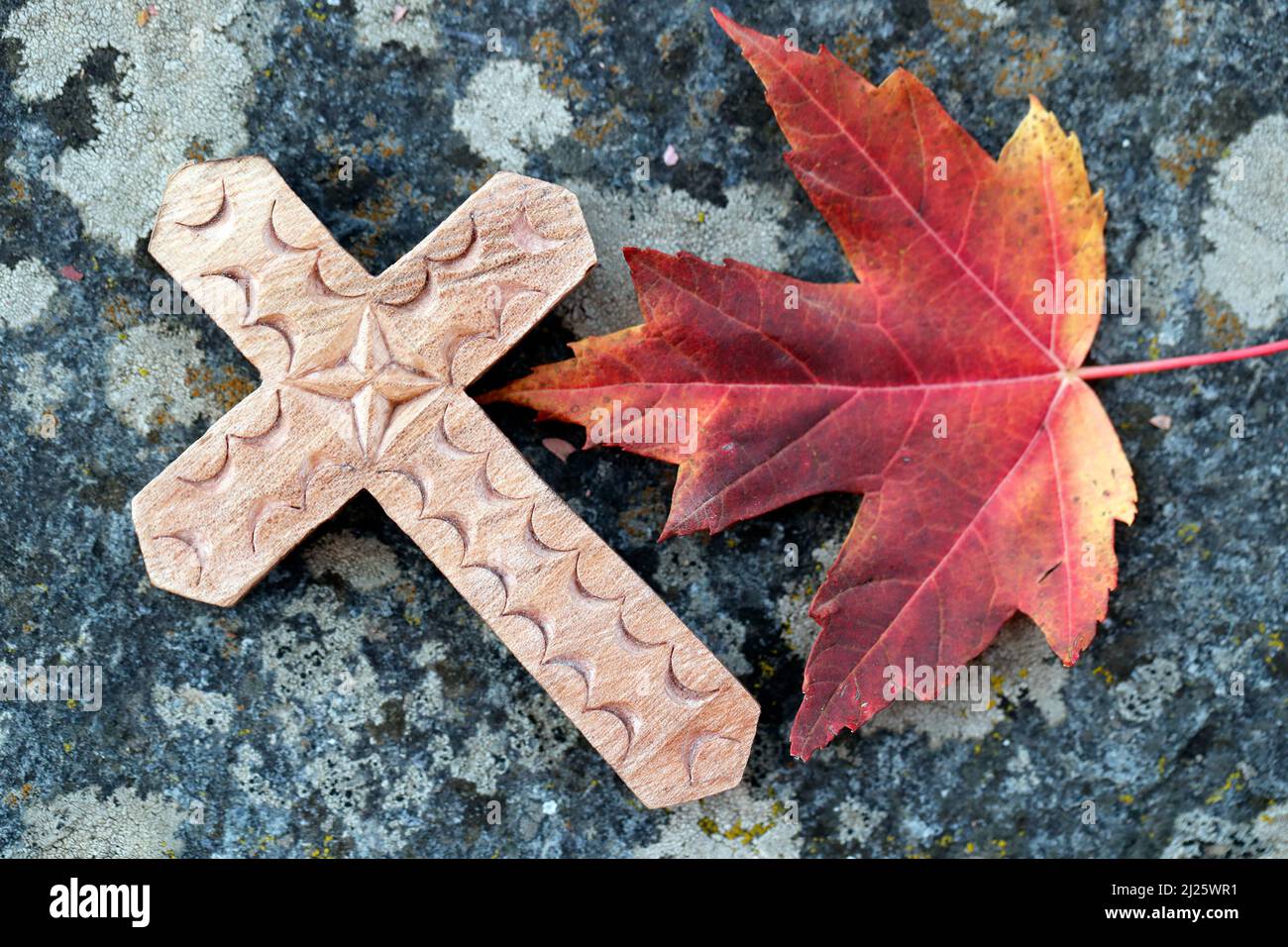 Christian wooden cross with autumn red leave Stock Photo - Alamy