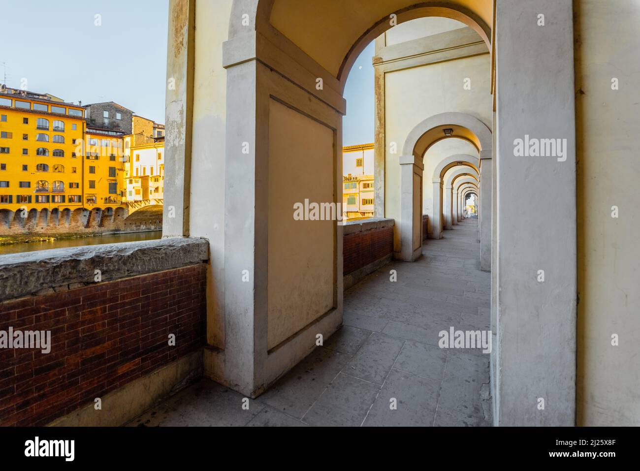 Beautiful arcade near famous Ponte Vecchio on Arno river in Florence ...