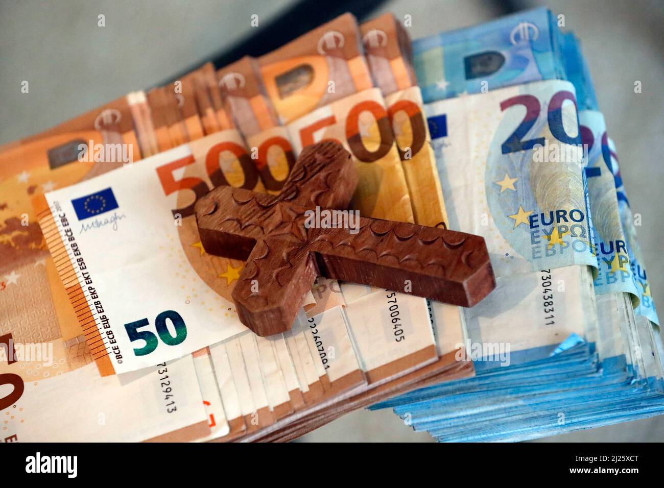 Christian cross with money. Concept of church business Stock Photo - Alamy