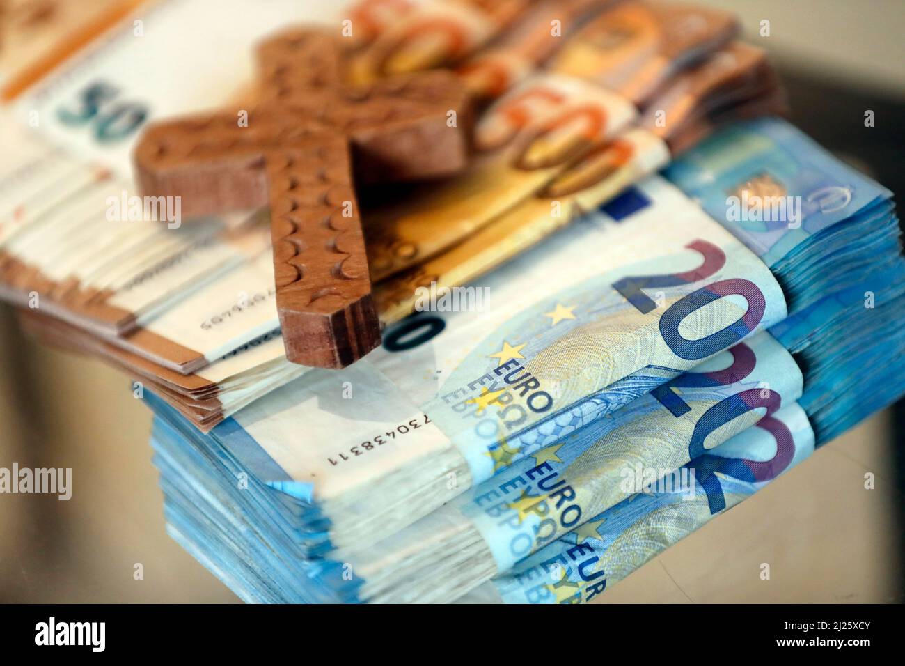 Christian cross with money. Concept of church business Stock Photo - Alamy