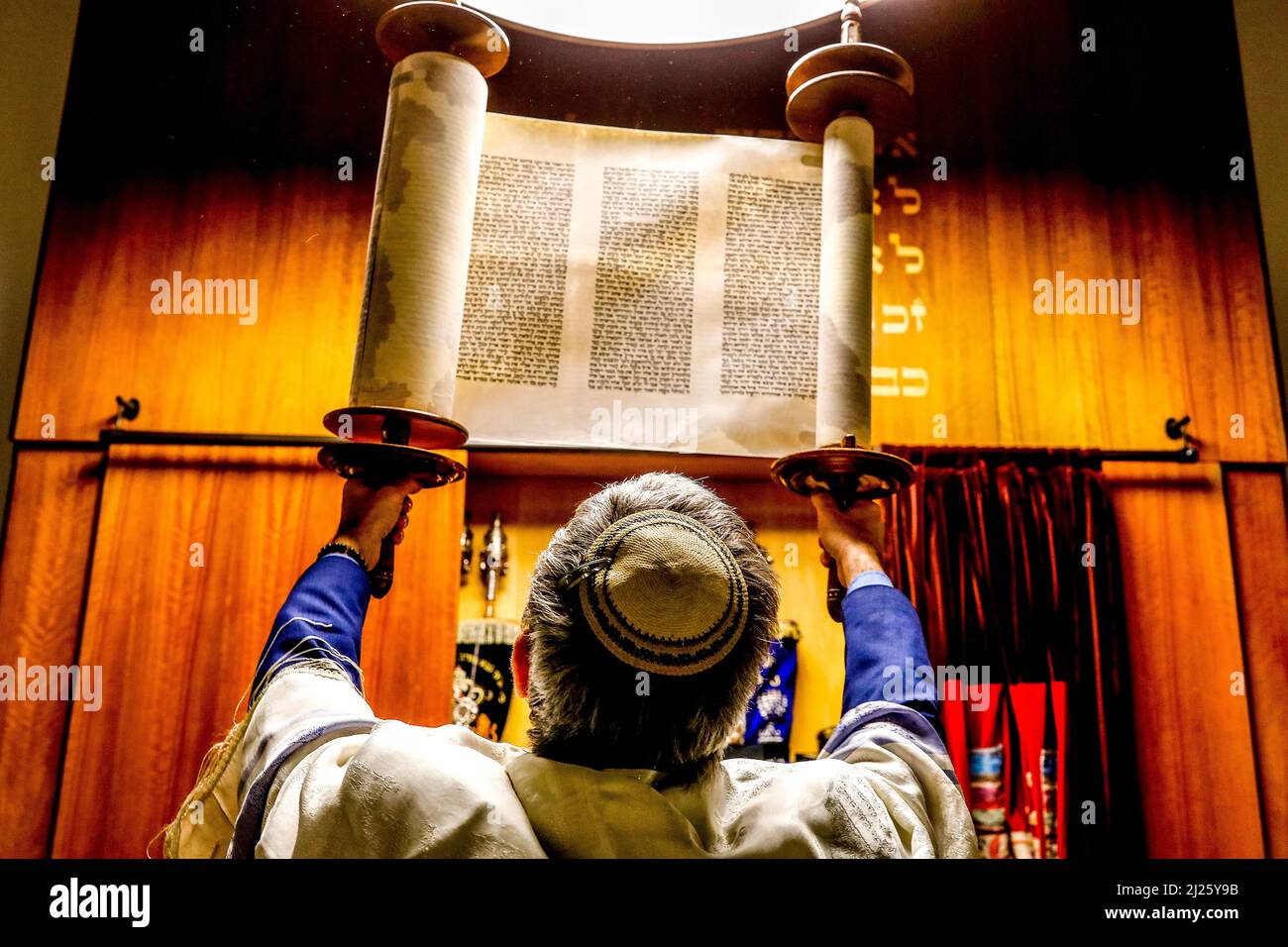 Rabbi holding up sefer torah scrolls, Paris, France Stock Photo - Alamy