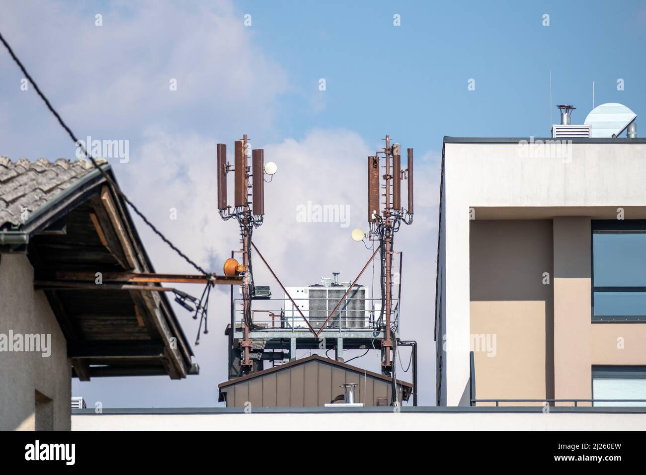 Mobile phone and internet cell tower over against sky. 5G wireless ...