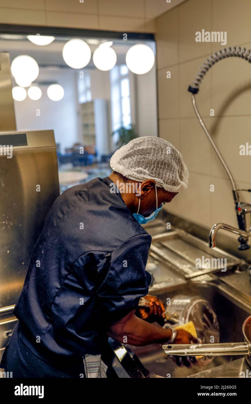 Migrant washing up in a kitchen in Paris, France Stock Photo - Alamy