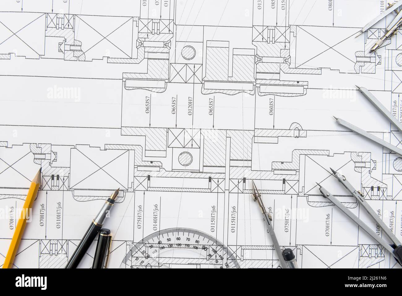 Paper with technical drawings and work tool on table. place of work ...