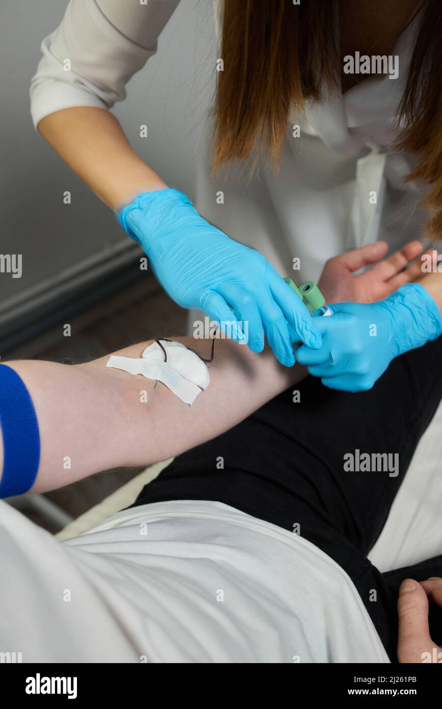Beautician doctor's hands put test tube with blood in centrifuge ...