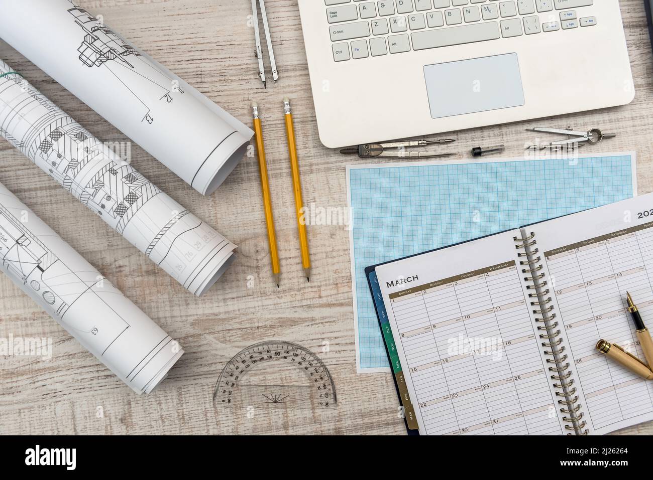 Workplace of engineer. Top view of laptop, notepad, and drawing tools ...