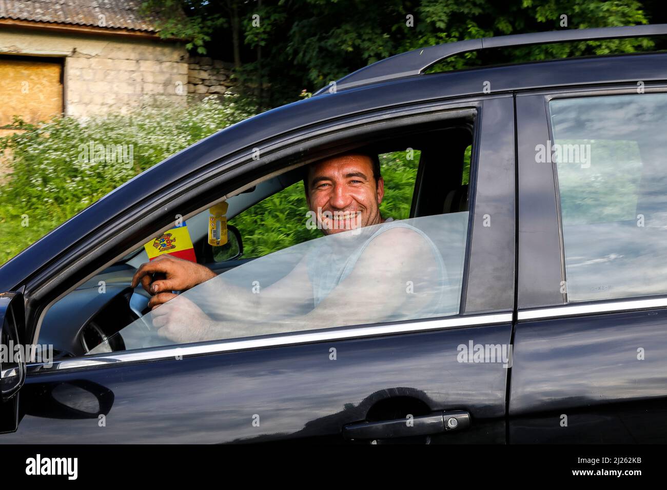 Smiling driver in a village near Soroca, Moldova Stock Photo - Alamy