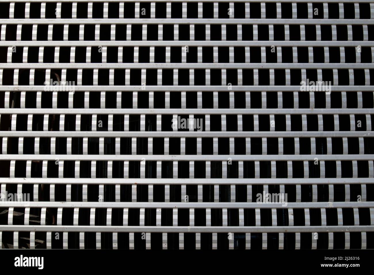 industrial storehouse with closed gray metal roller shutter Stock Photo ...