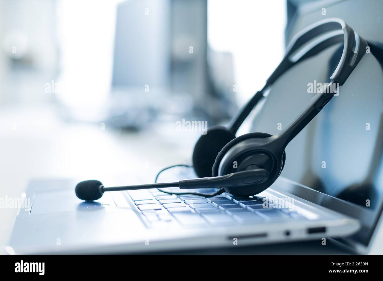 Call center operator desktop. Close-up of a headset on a laptop. Help ...