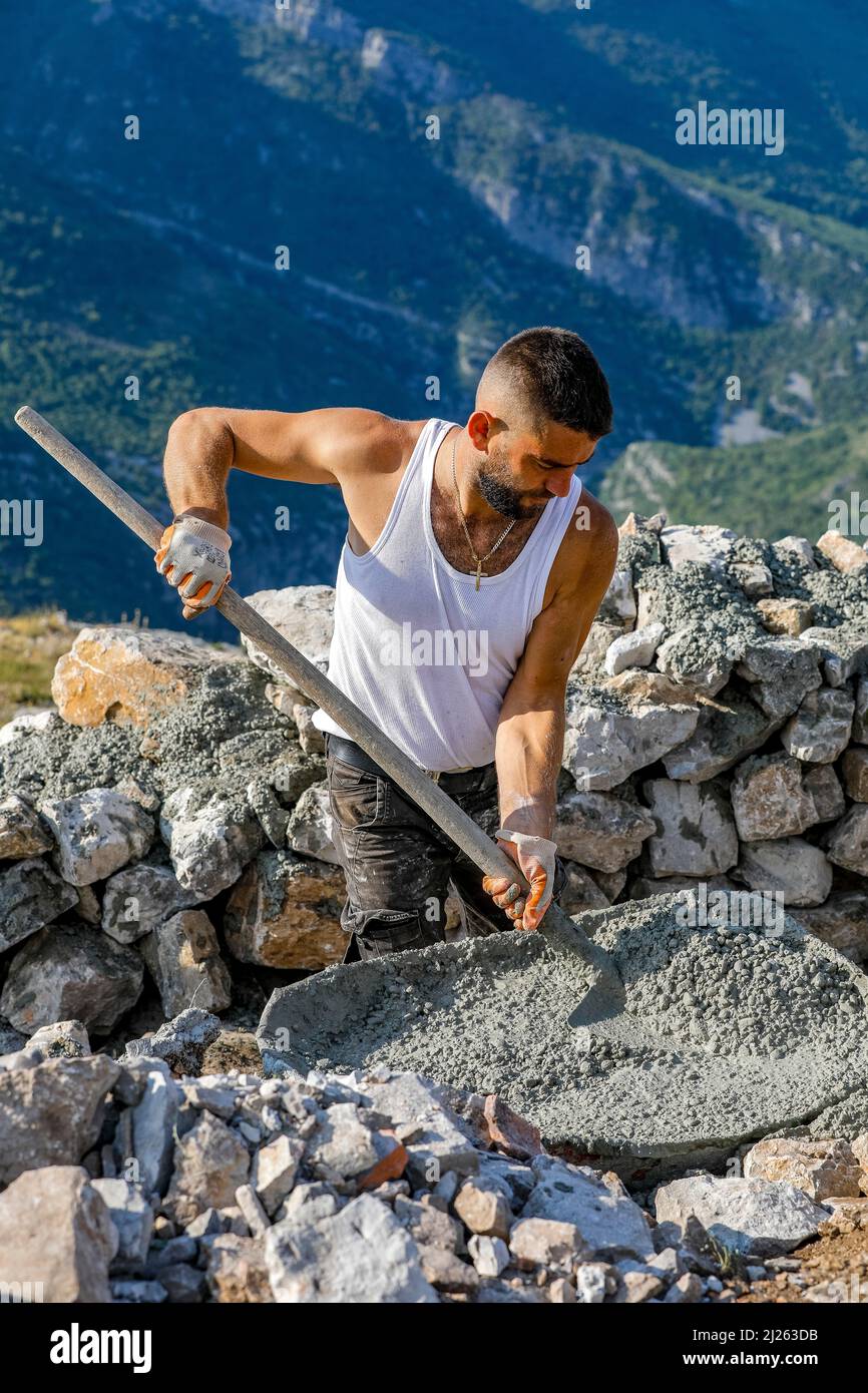 Christian Albanian builder at work in Delaj, montenegro Stock Photo - Alamy