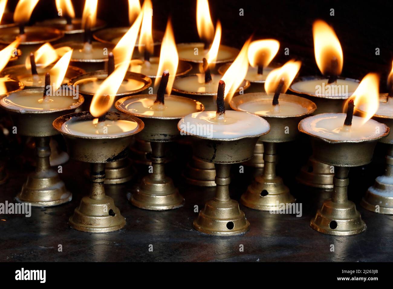 Oil butter lamps burning in hindu temple hi-res stock photography and ...